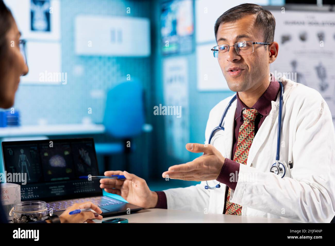 Medical staff reviewing diagnostic reports and test results for a ...