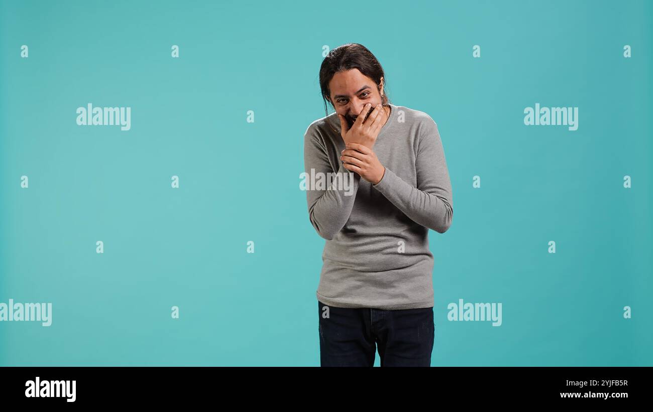 Portrait of cheerful man laughing hard, amused by funny joke, studio ...