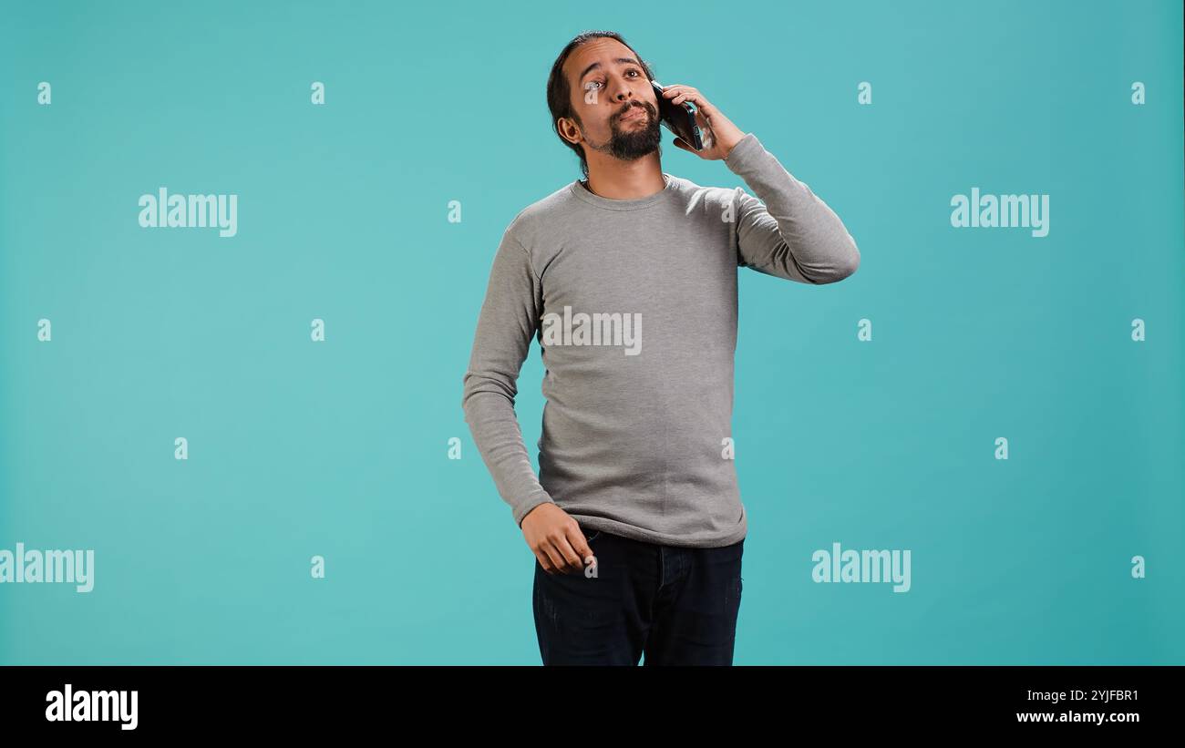 Joyous man catching up with friends in phone call using cellphone ...