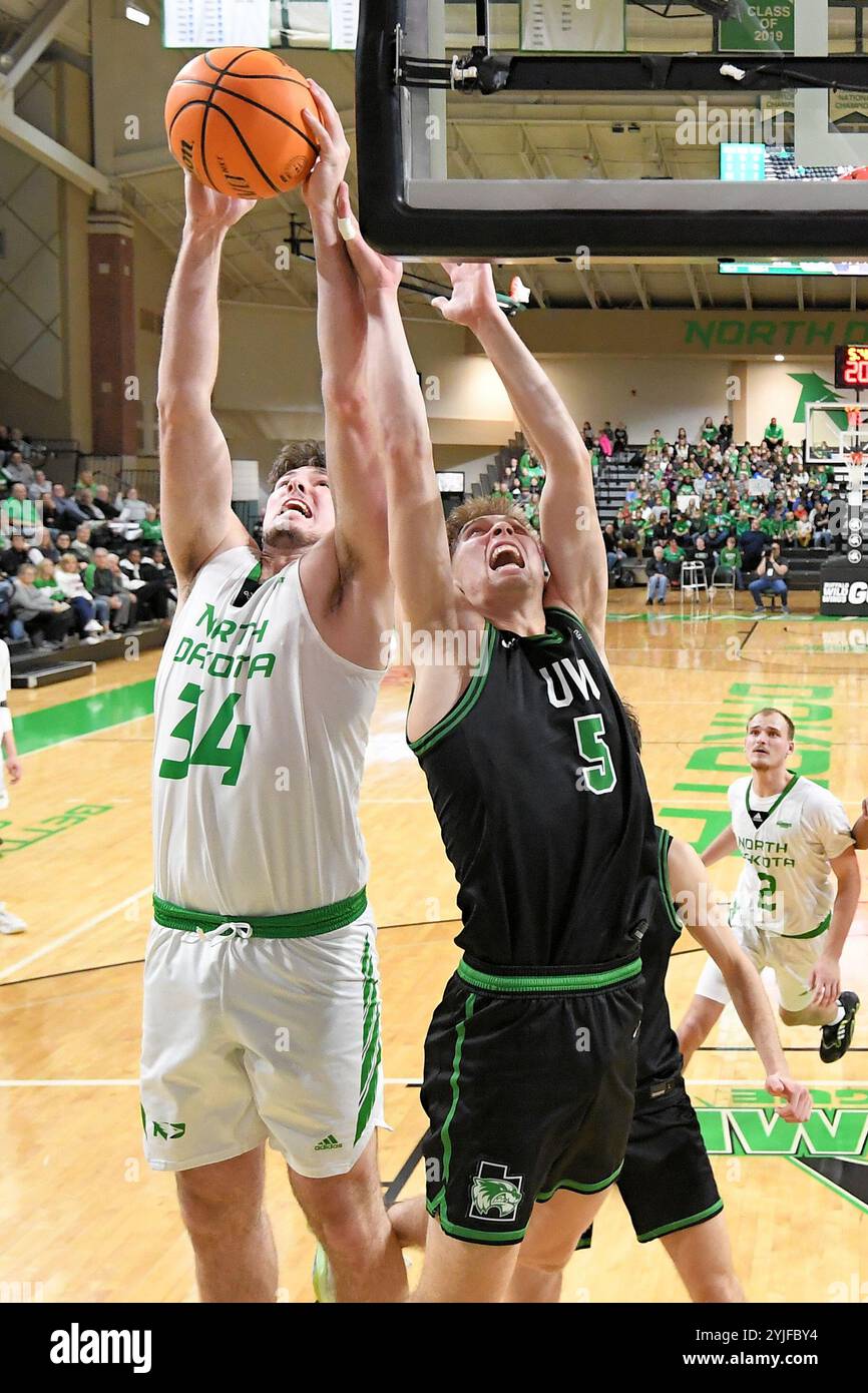 North Dakota Fighting Hawks forward Brian Mathews (34) and Utah Valley Wolverines guard Tanner ...