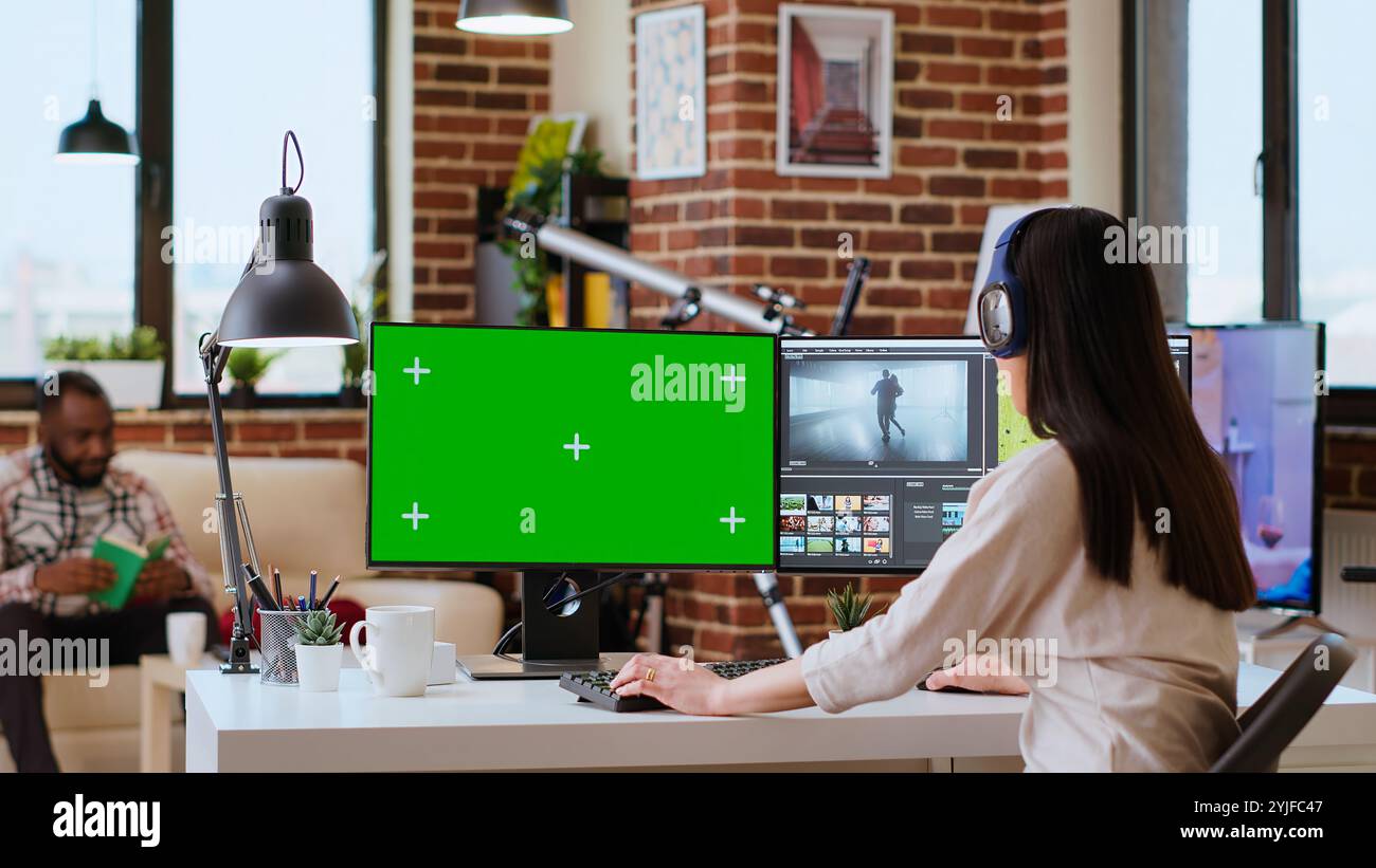 Asian woman working from home as a freelance video editor, using ...