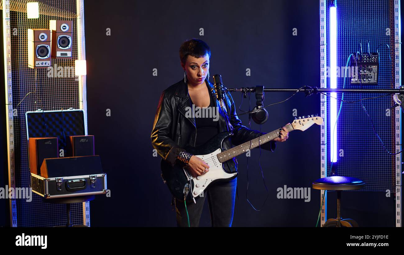 Female guitarist plays music performing hi-res stock photography and ...