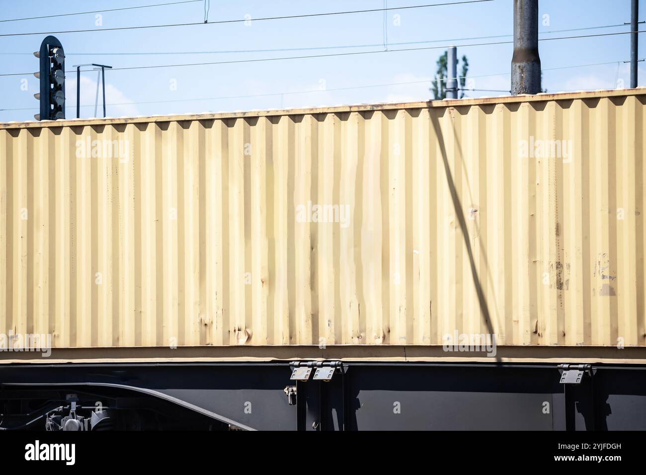 This image displays a yellow container on a train, illustrating the ...