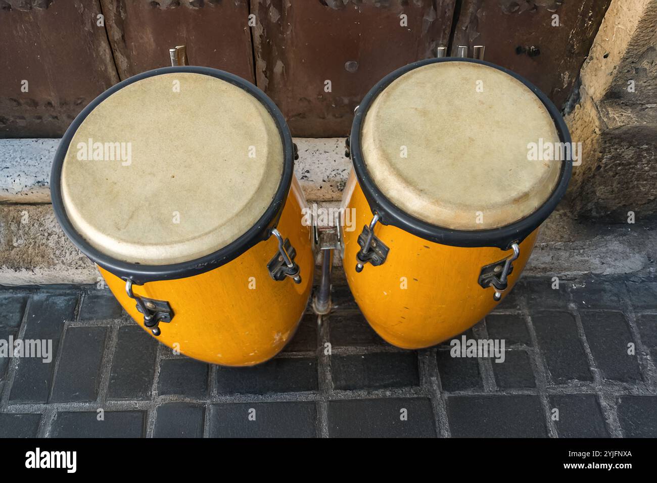 Big yellow bongos set on a street Stock Photo - Alamy