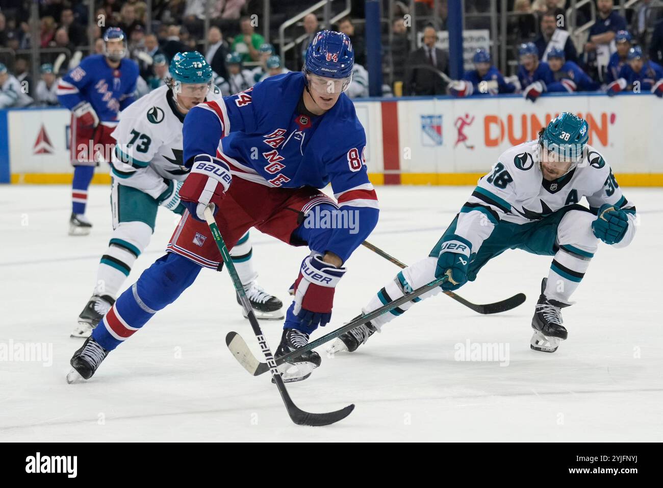 New York Rangers' Adam Edstrom, left, brings the puck up the ice as San ...