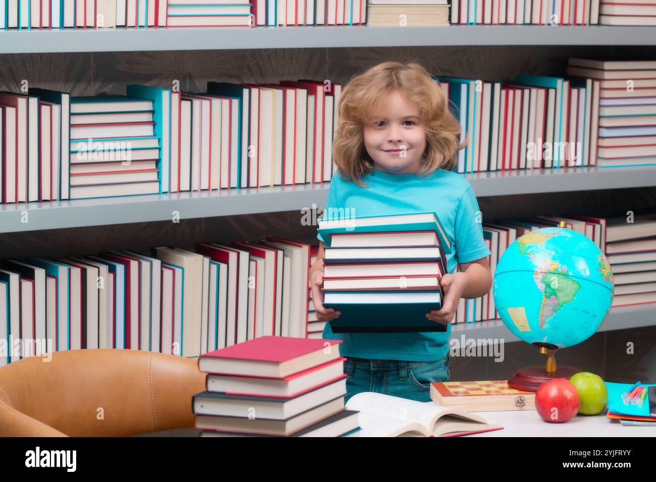 School boy with stack of books in library. School kids. Child from ...