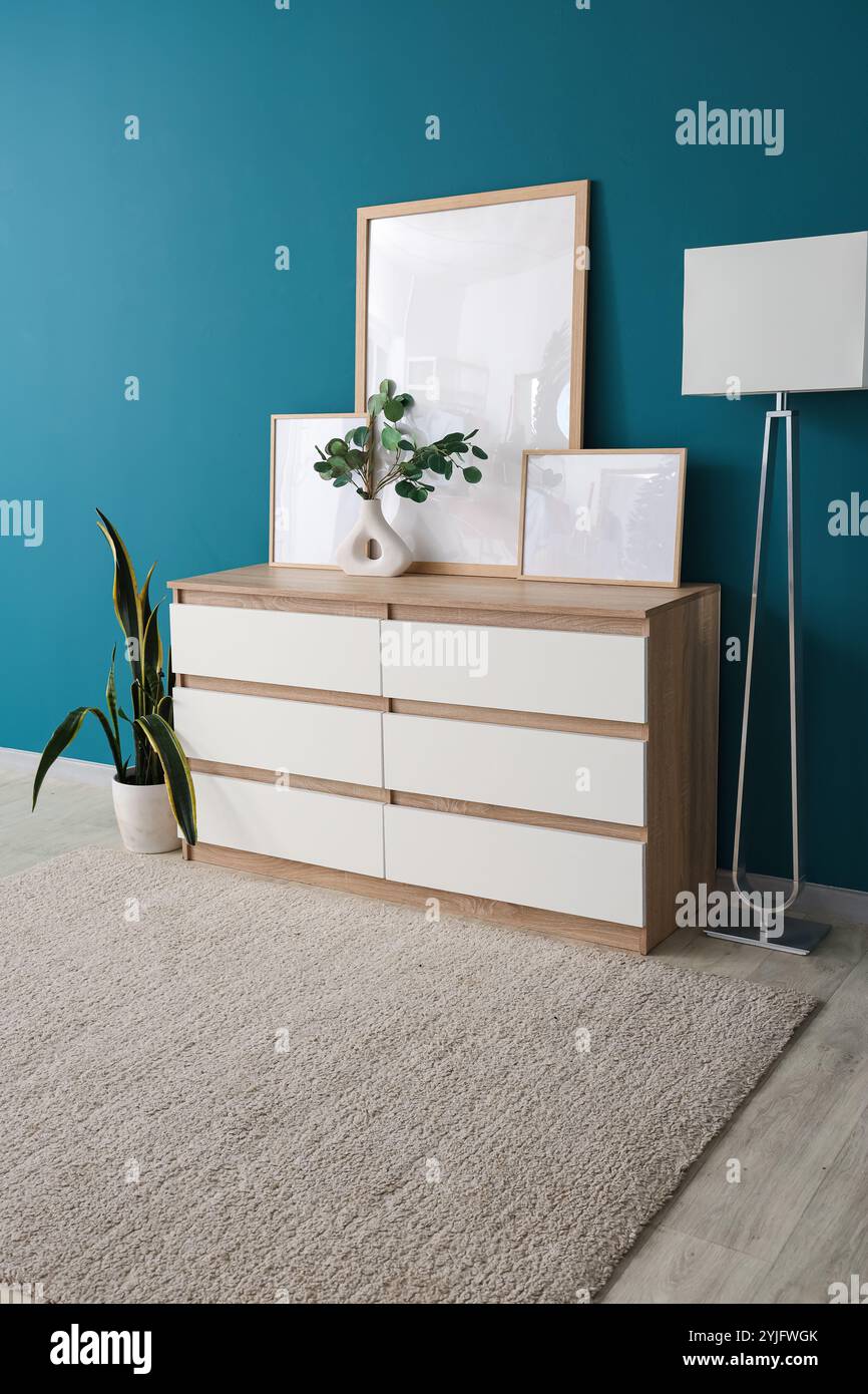 Interior of living room with soft carpet, drawers and lamp Stock Photo ...