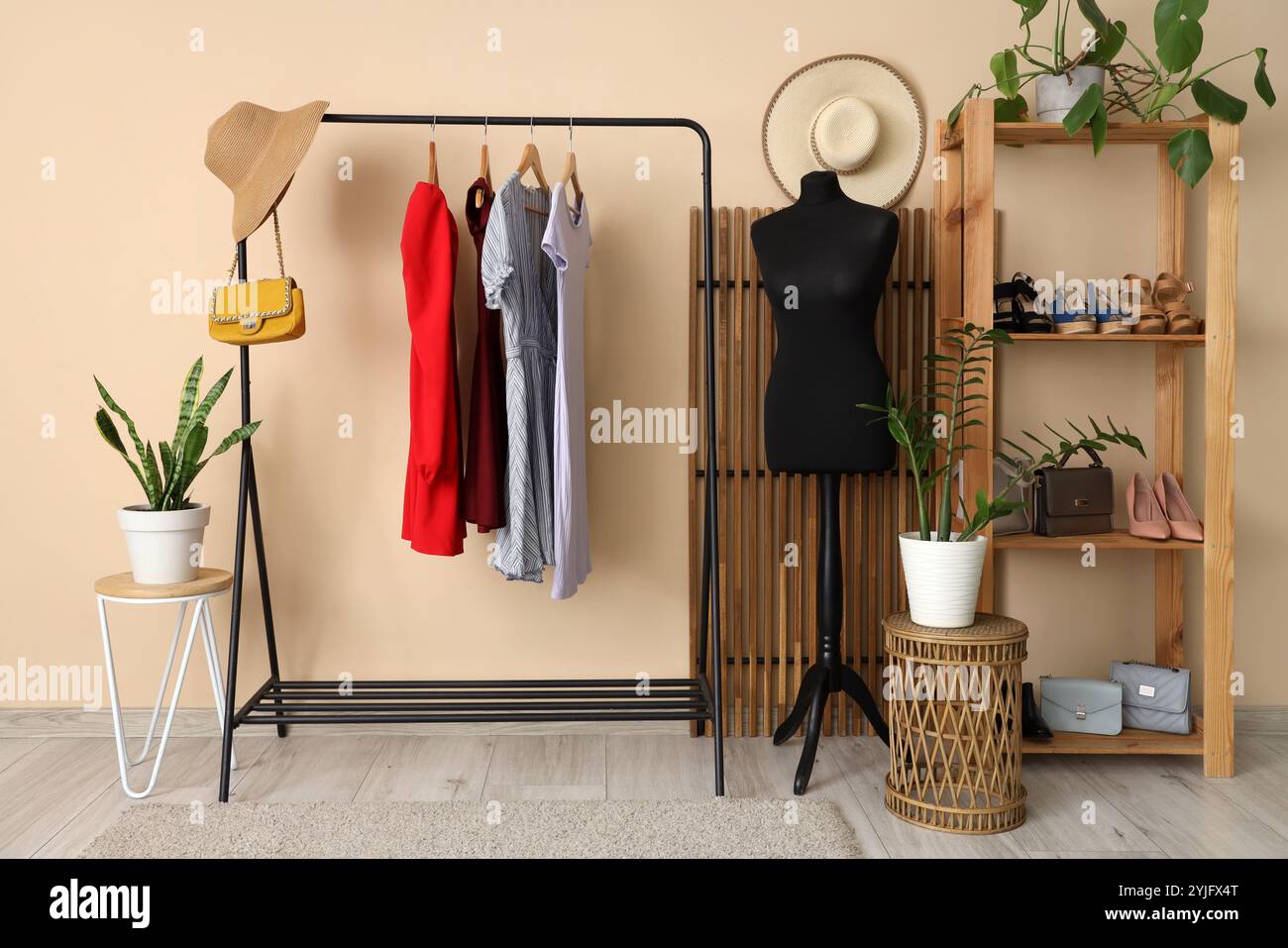 Interior of dressing room with mannequin, clothes rack and shelf unit ...