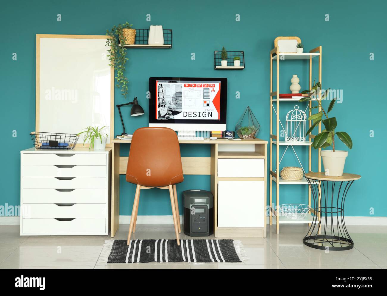 Interior of designer's office with workplace, shelf unit and drawers ...