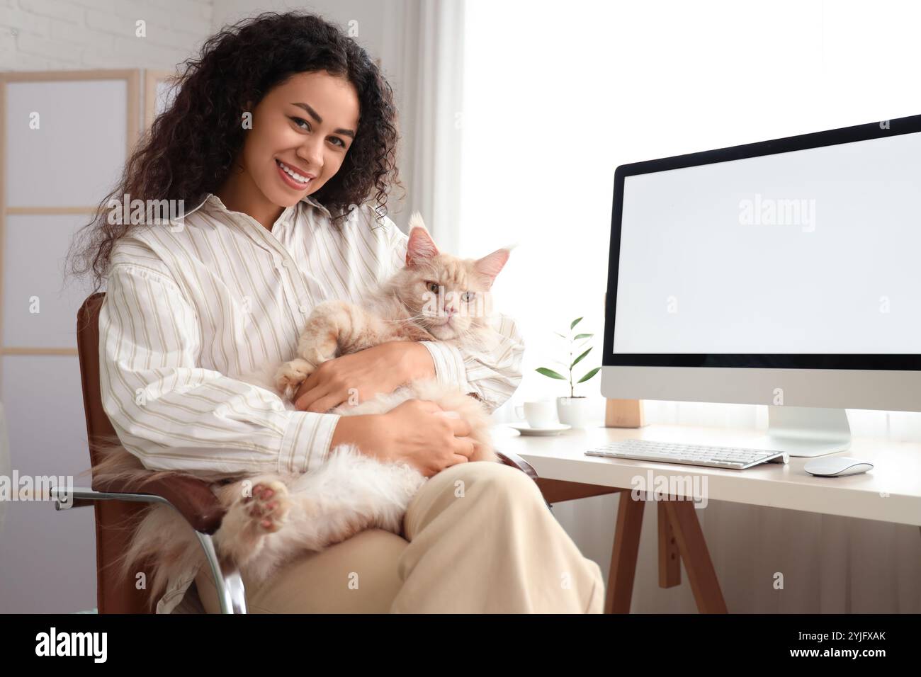 Beautiful young happy African-American woman working with her cute ...