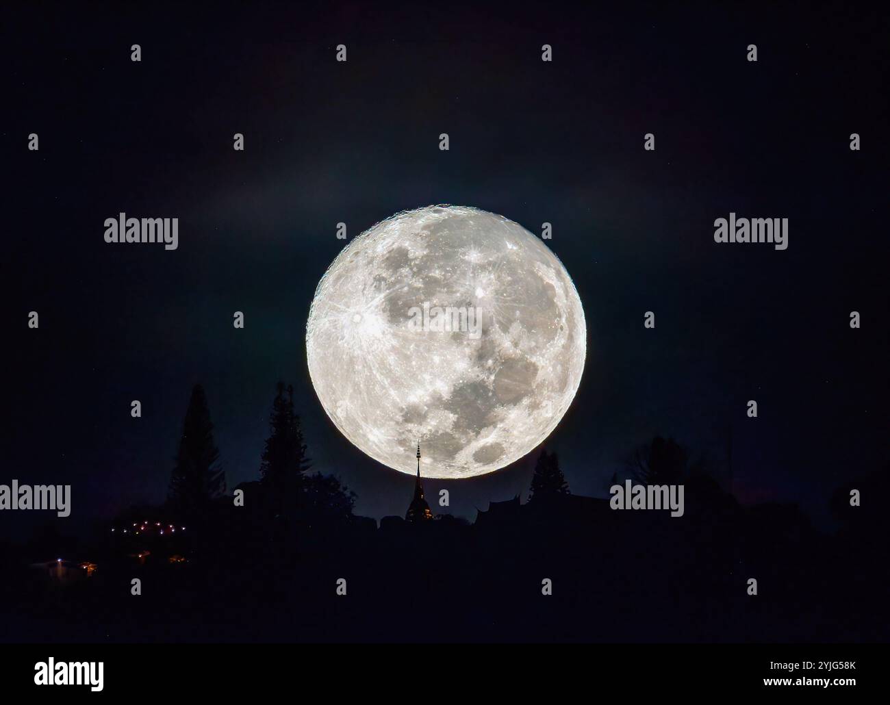 The full moon known as 'Beaver Moon' sets shines above the spire of Wat ...
