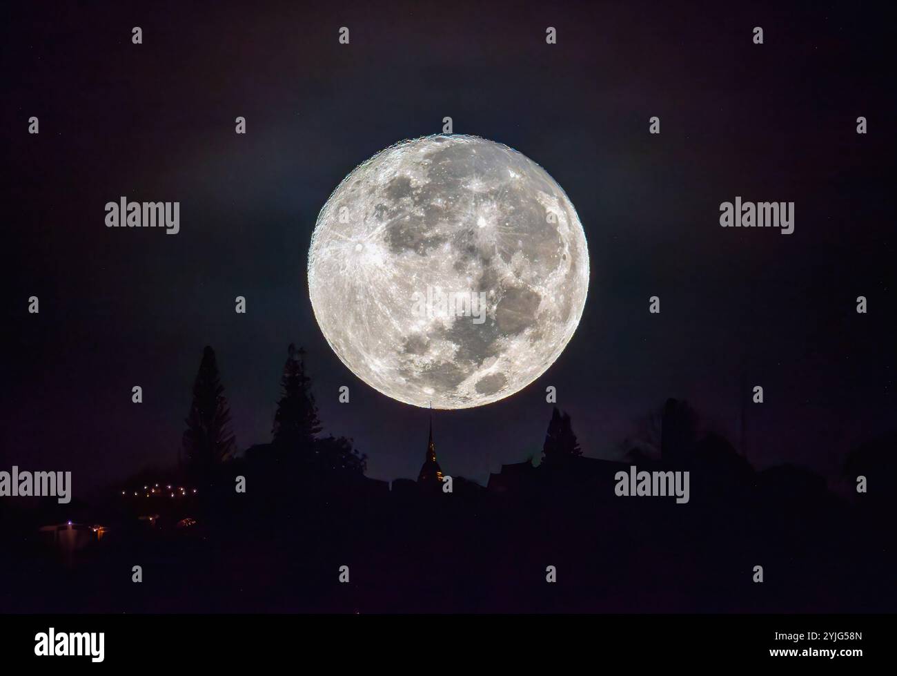 The full moon known as 'Beaver Moon' sets shines above the spire of Wat ...
