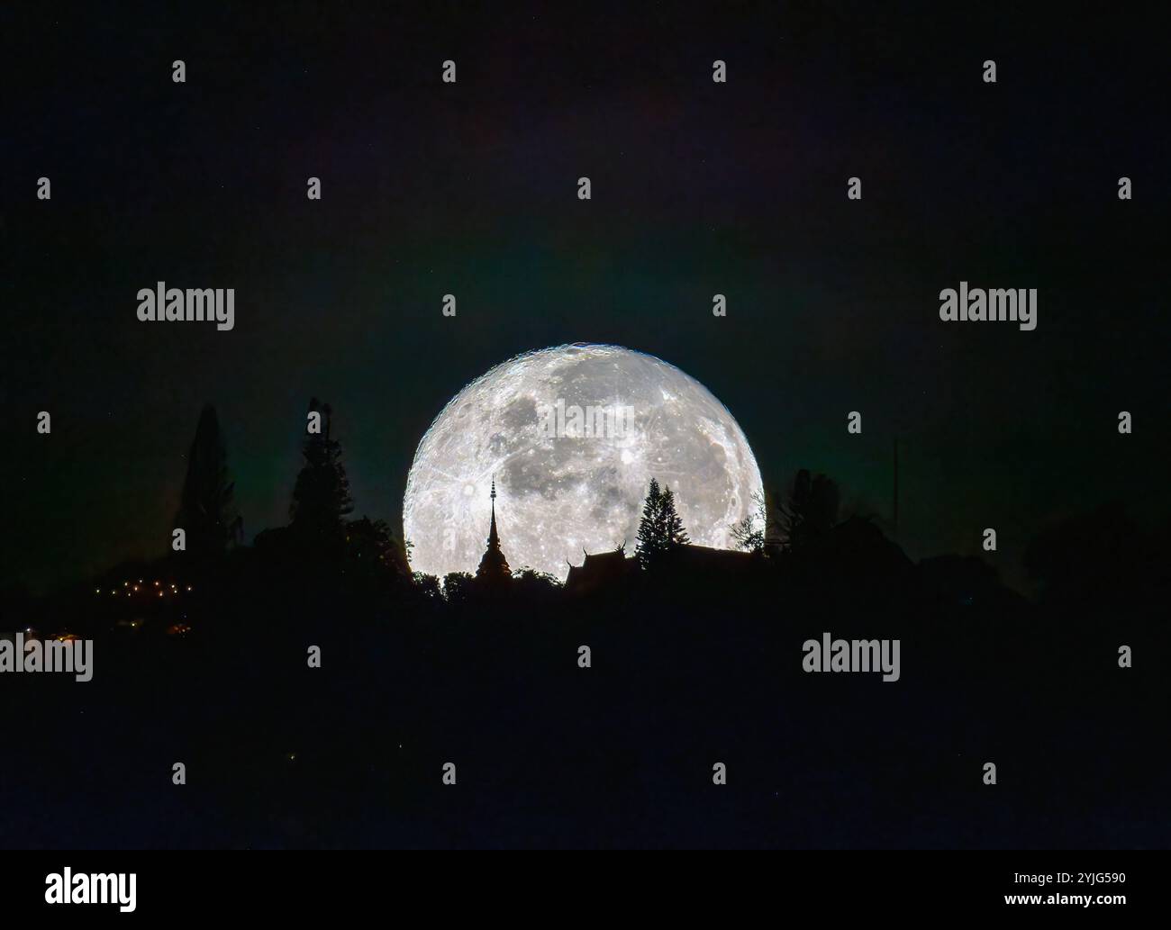 The full moon known as 'Beaver Moon' sets behind the pagoda of Wat Phra ...