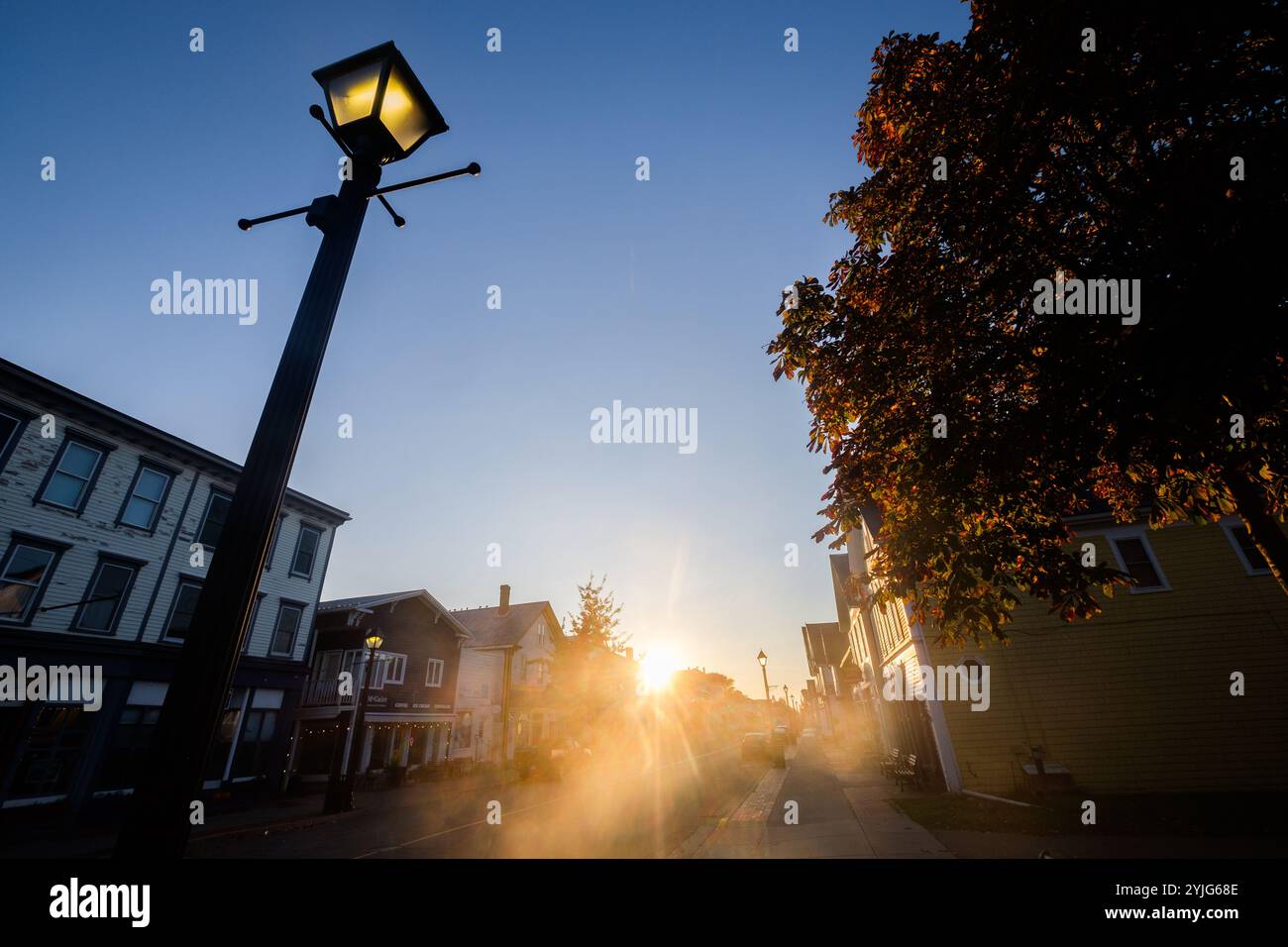 Street lamp as sun rises on Water Street in St. Andrews, New Brunswick ...