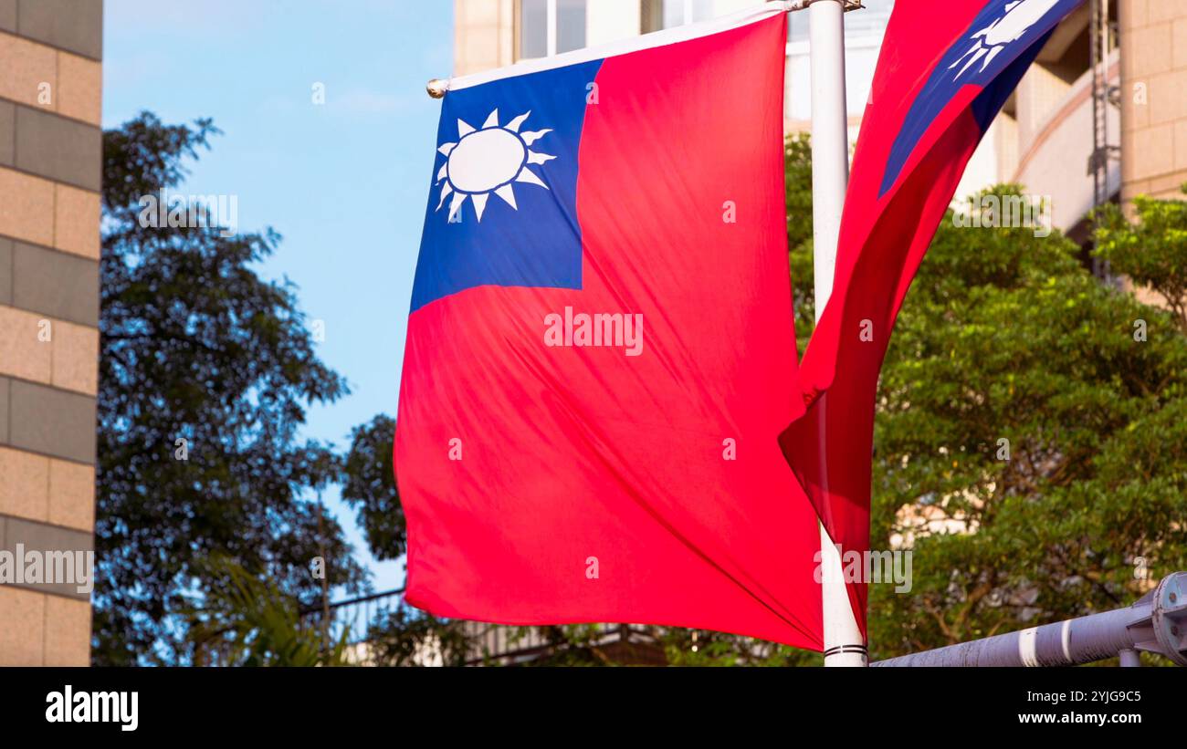 A pair of Taiwan flags waving gracefully on a pole, set against a ...