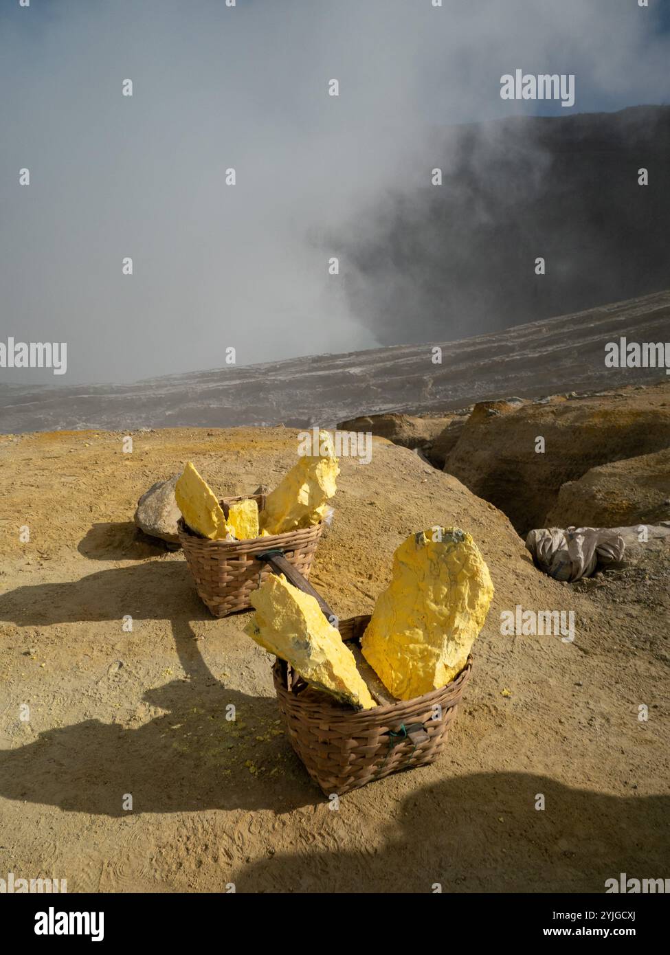 Raw Sulfur in a basket after mining, Kawa Ijien volcanic crater ...