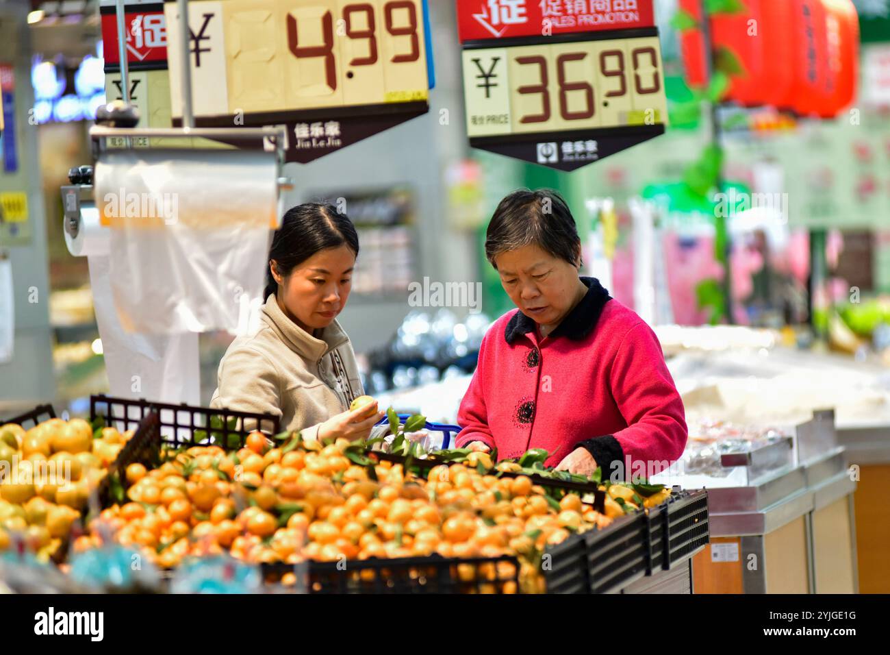 Consumers shop at a supermarket in Qingzhou city, East China's Shandong ...