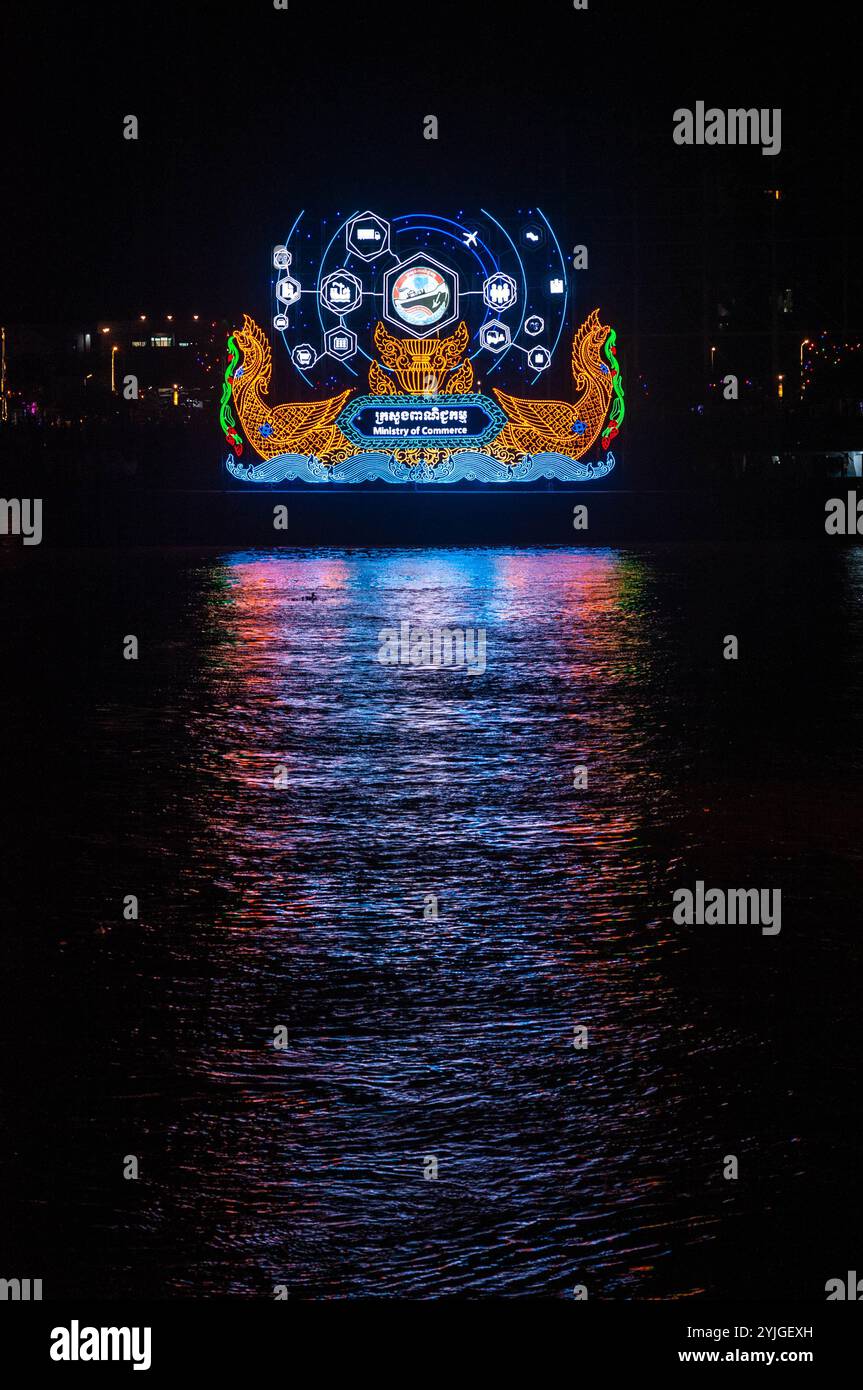 an Illuminated float / barge casts its reflection on the Tonle Sap ...
