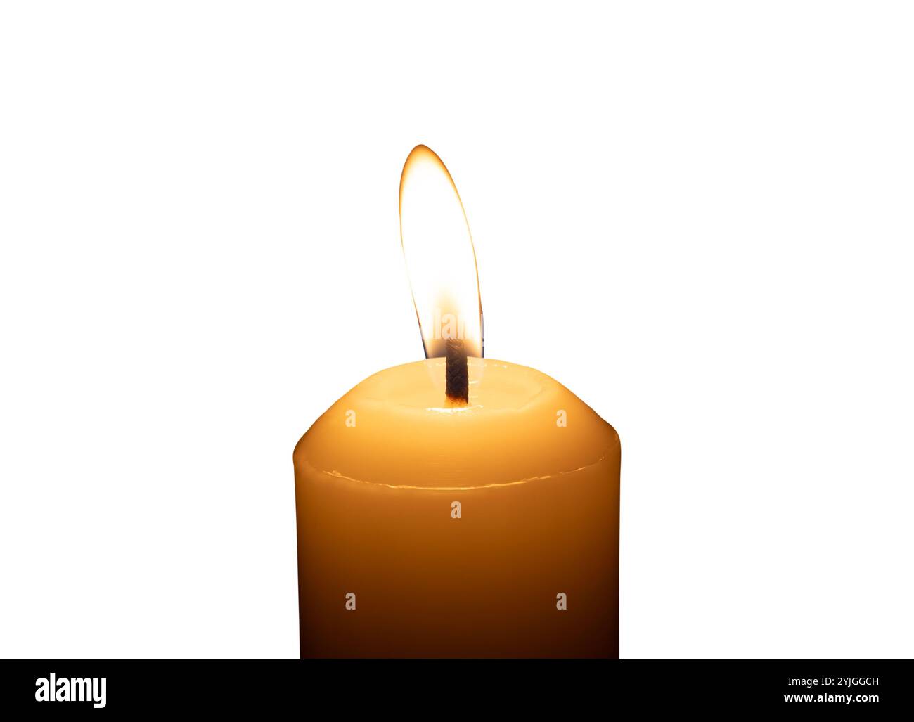 A single burning candle flame or light glowing on a big white candle is ...