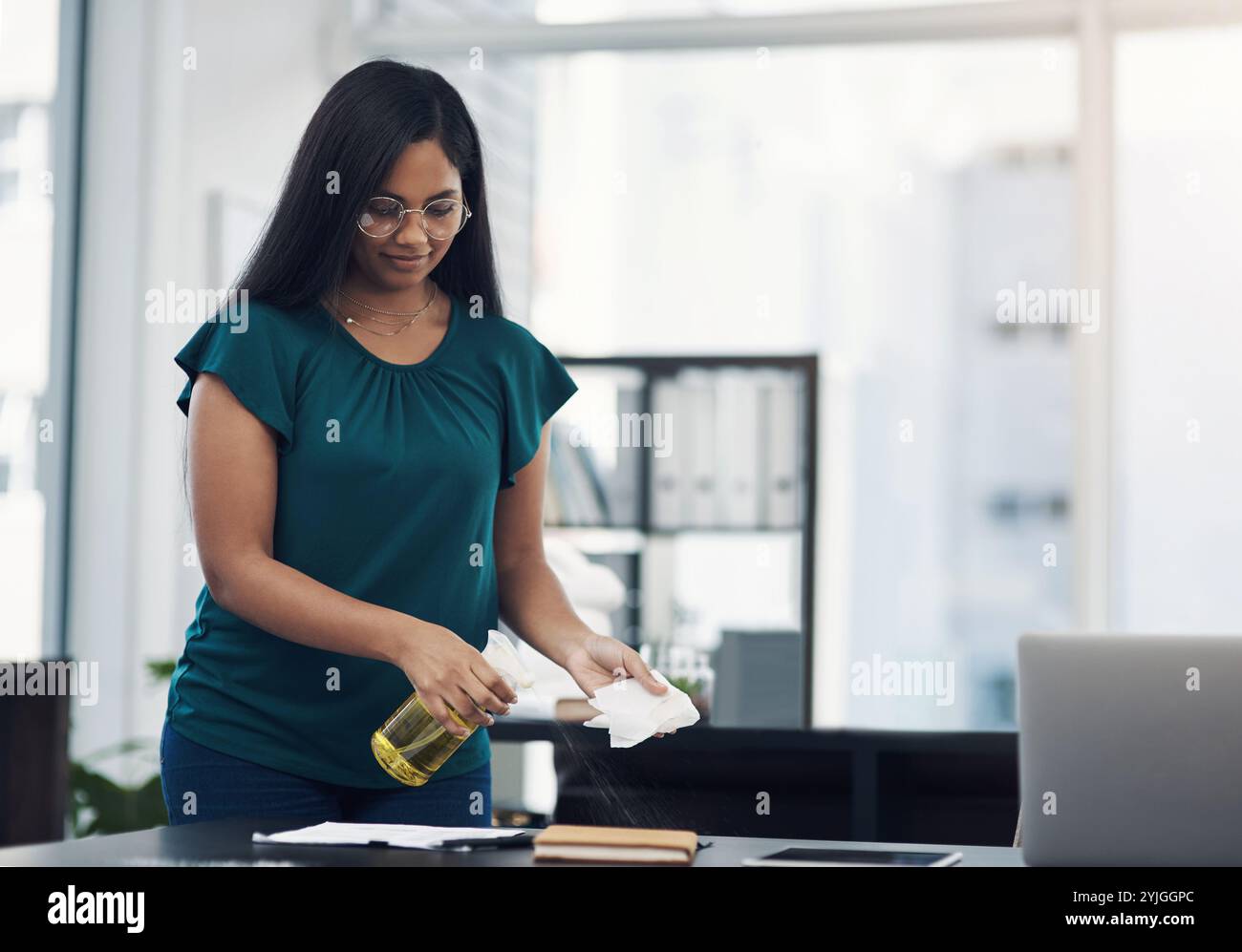 Woman, office and spray for cleaning desk, employee and disinfection of ...