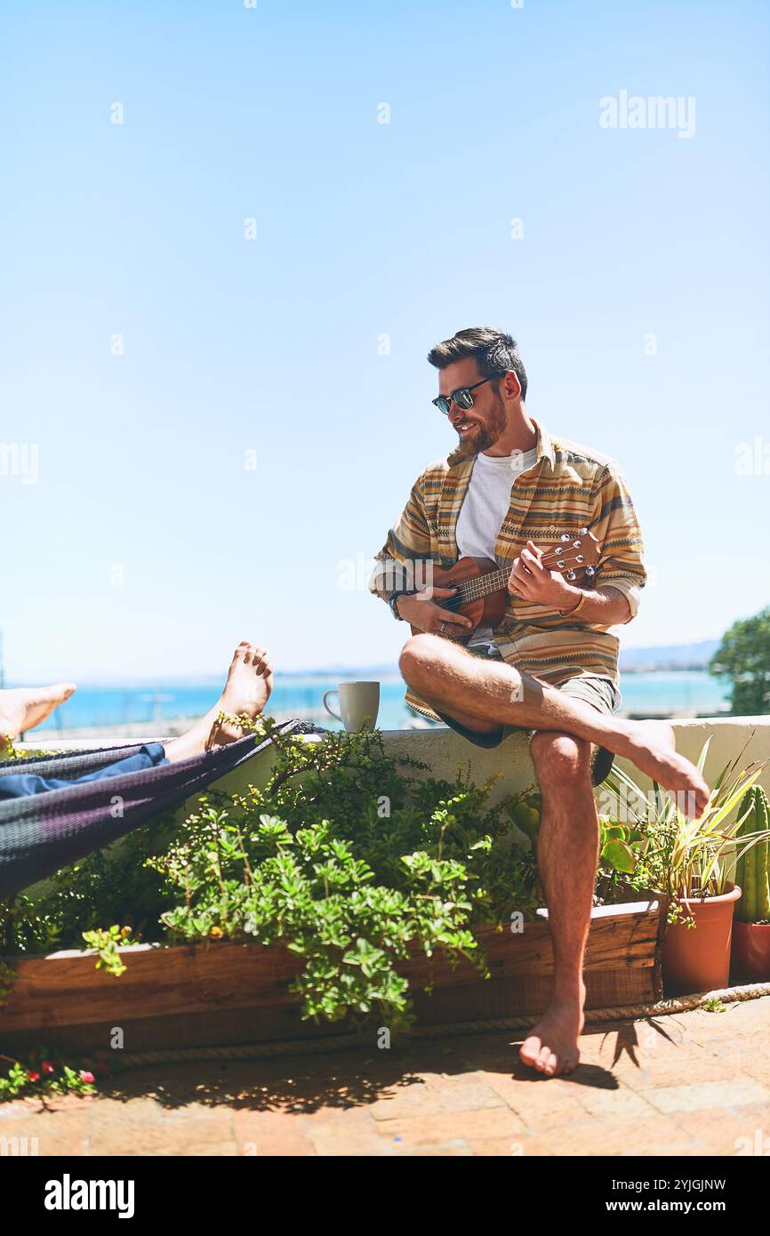 Friends, balcony and men with ukulele for playing in backyard for ...