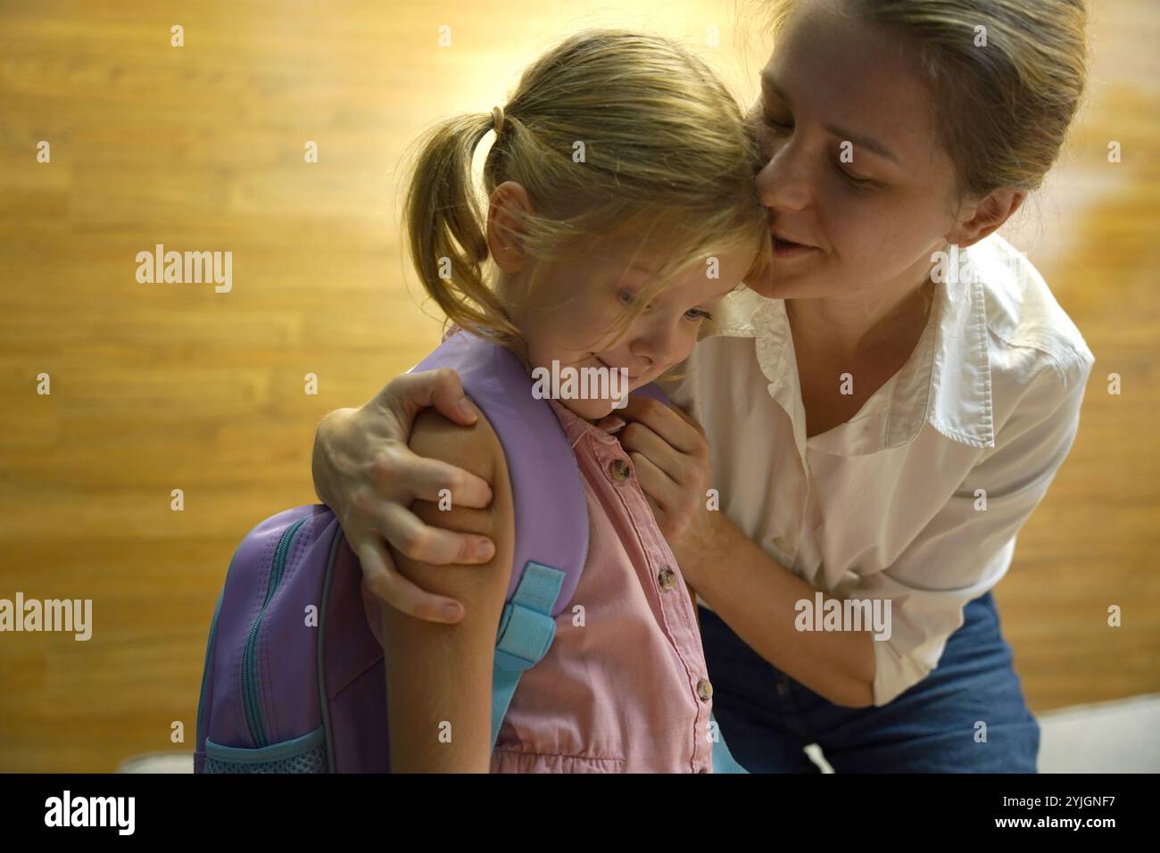 Mother helps her daughter pack her backpack Stock Photo - Alamy