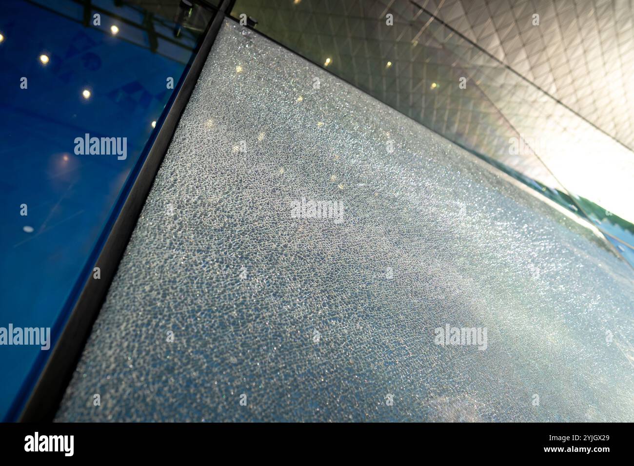 Shattered facade glass panel with visible cracks, no falling. Smart ...