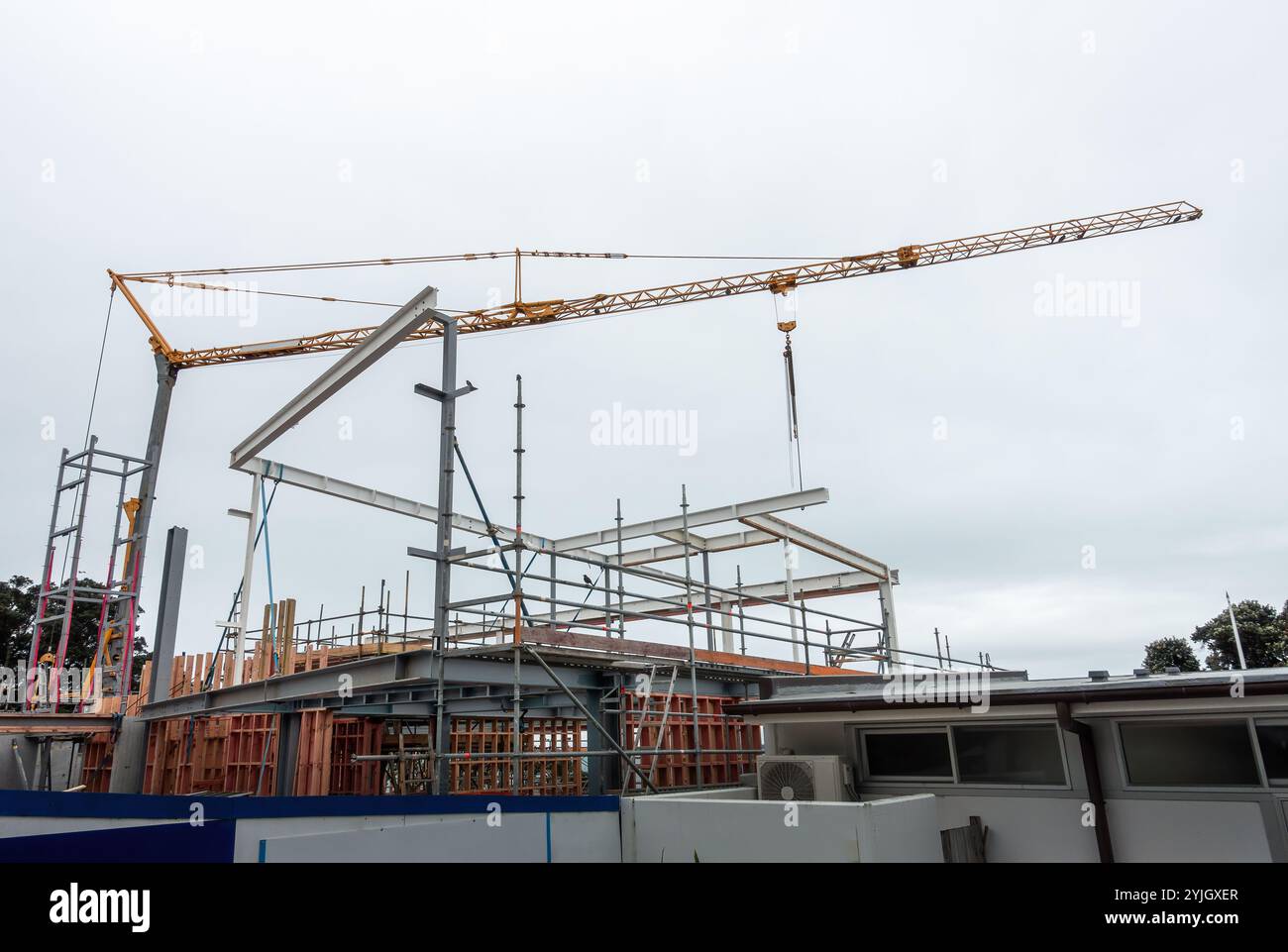 A construction crane over a commercial building Stock Photo - Alamy