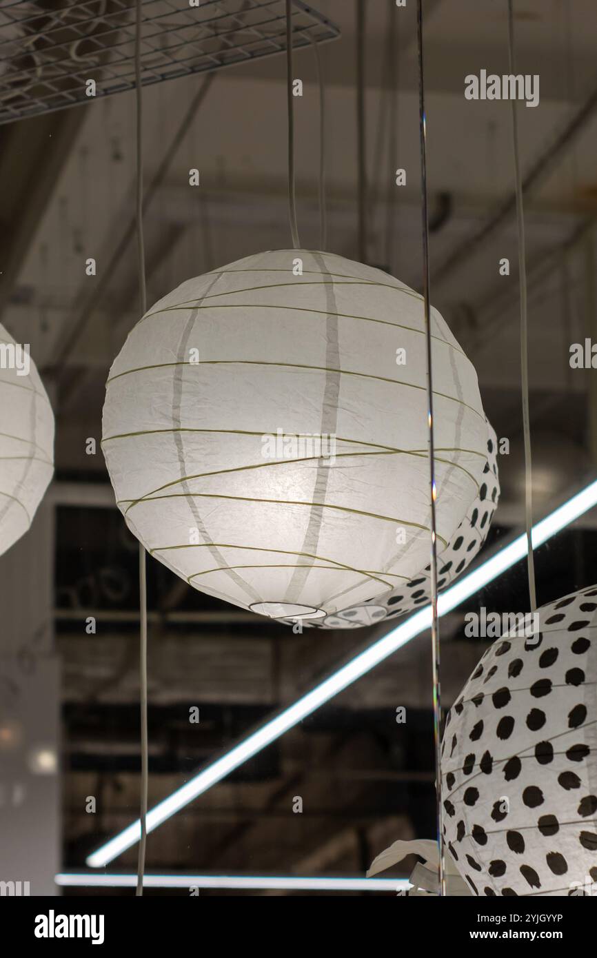 A beautiful arrangement of white polka dot lanterns gracefully hanging ...