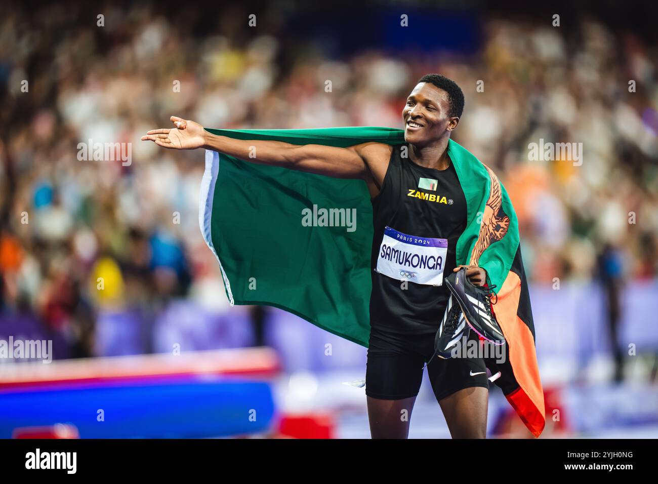 Muzala Samukonga celebrating her victory with her country's flag at the ...