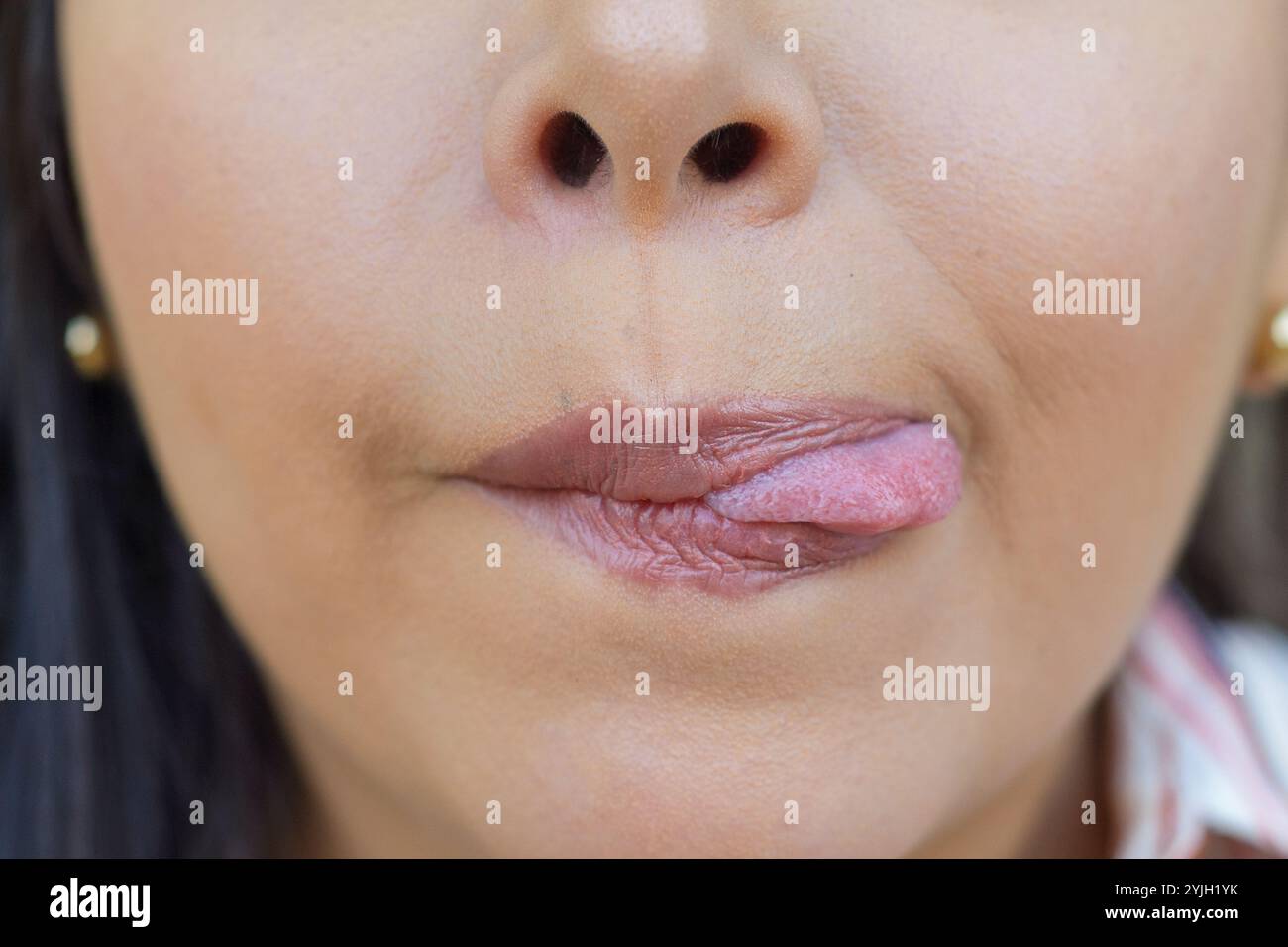 Close-up of a female nose and lips showing her tongue Stock Photo - Alamy