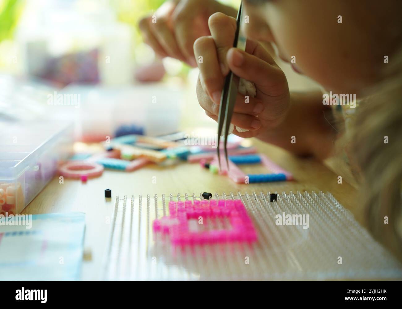 Teacher in workshop teched two girls how to assemble a thermo mosaic ...