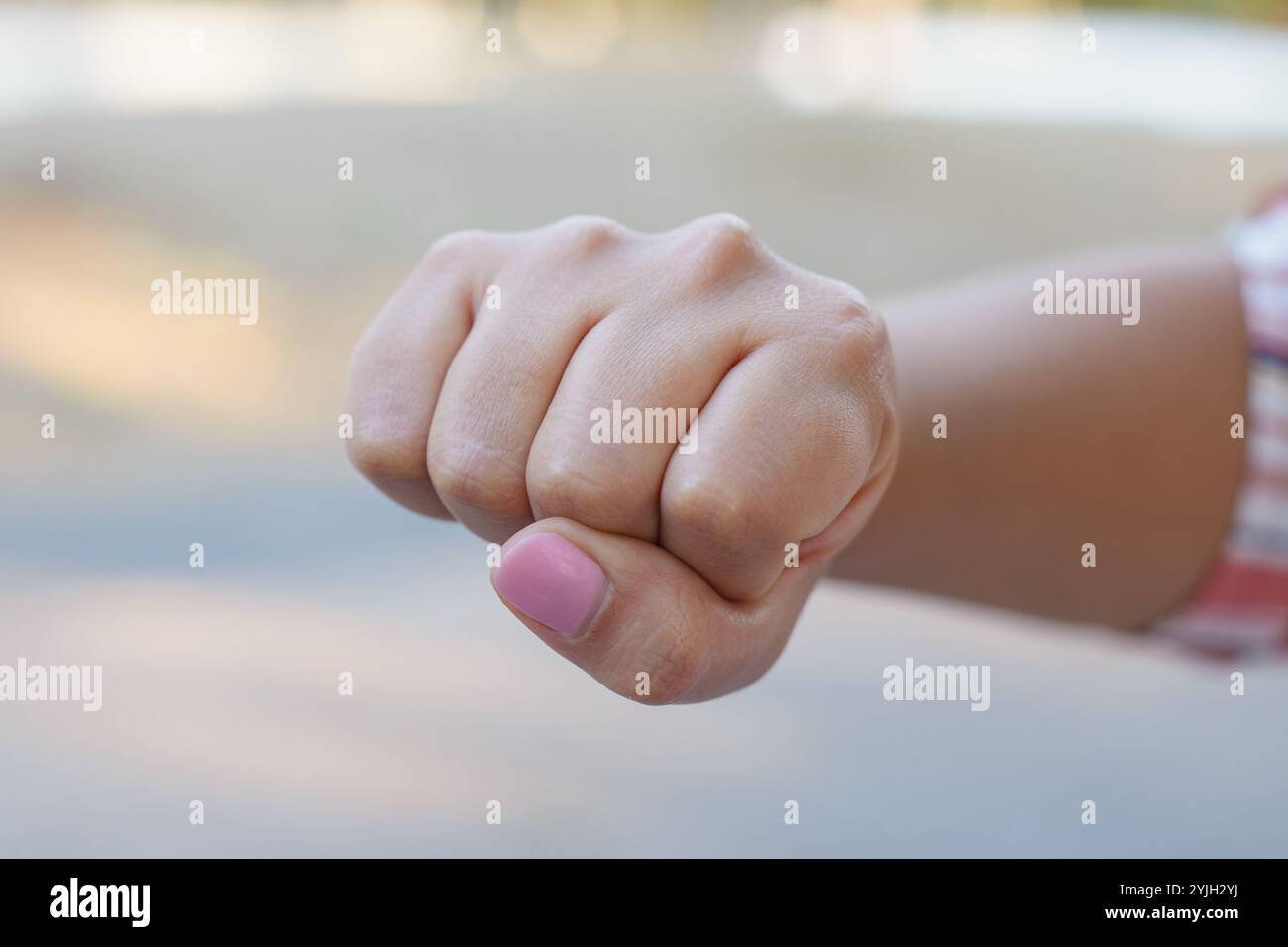 Close-up of a female clenched fist with pink nails Stock Photo - Alamy