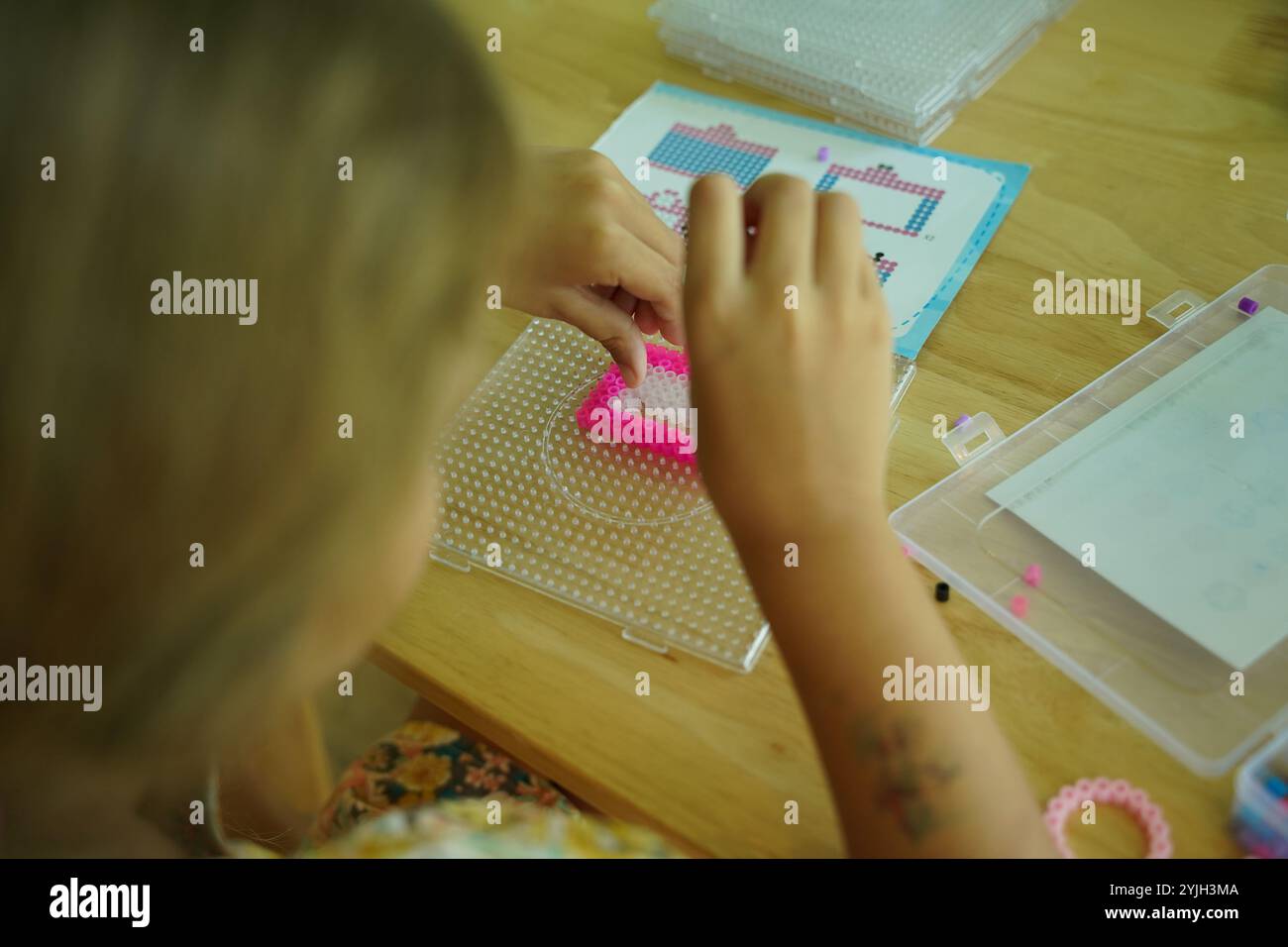 Teacher in workshop teched two girls how to assemble a thermo mosaic ...