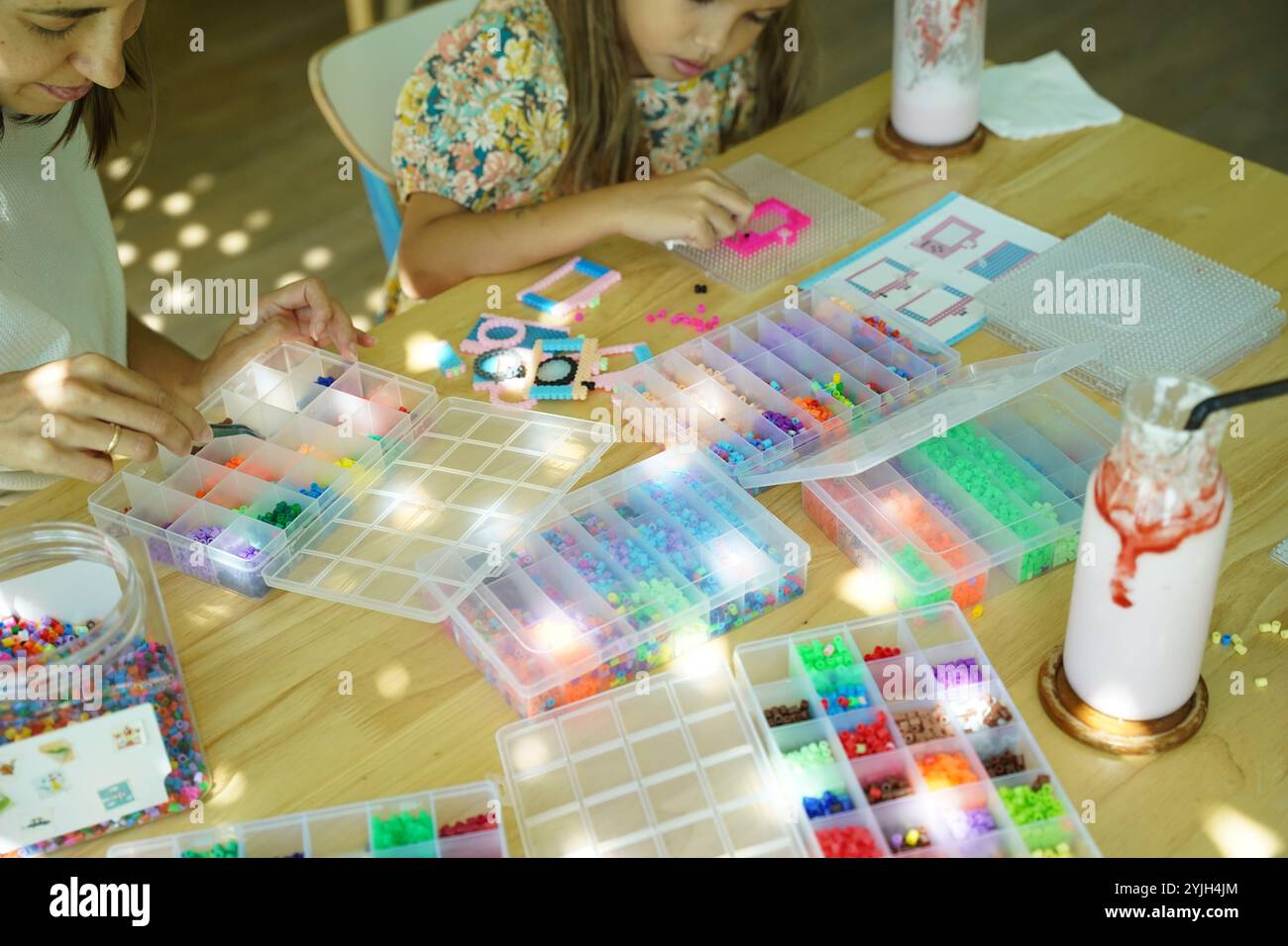 Teacher in workshop teched two girls how to assemble a thermo mosaic ...