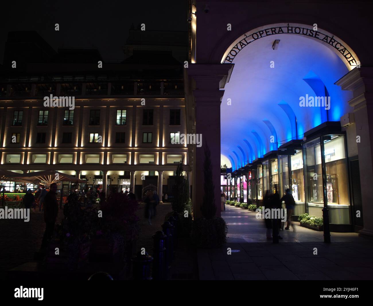 Illuminated entrance of the Royal Opera House Arcade at night in Covent ...