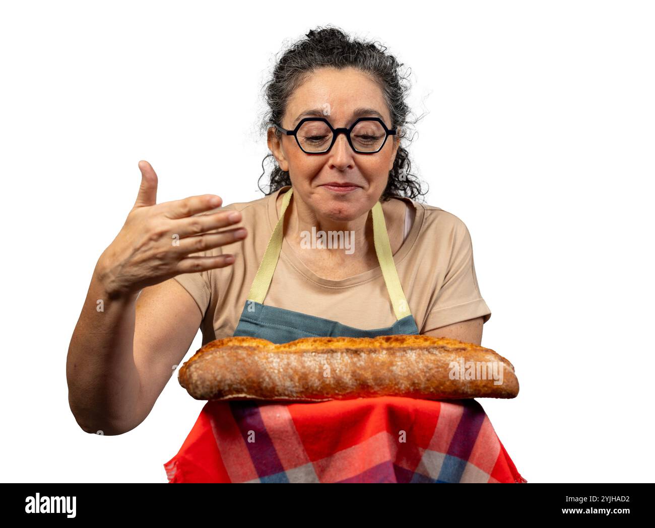 Baker woman wearing apron and glasses smelling a freshly baked loaf of ...