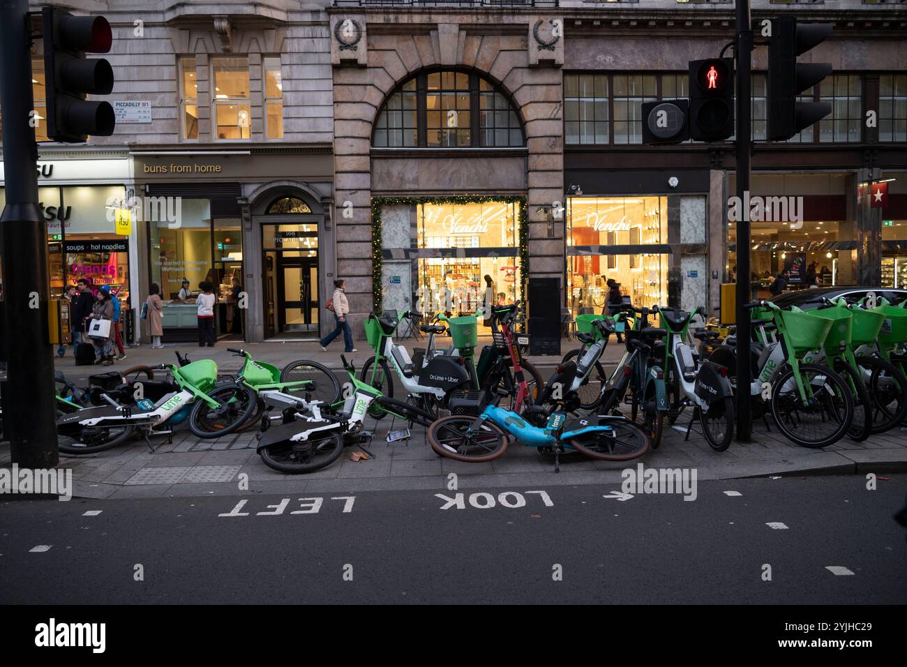 LIME e-bikes left blocking the pavement along Piccadilly, in the heart of London's Mayfair ...