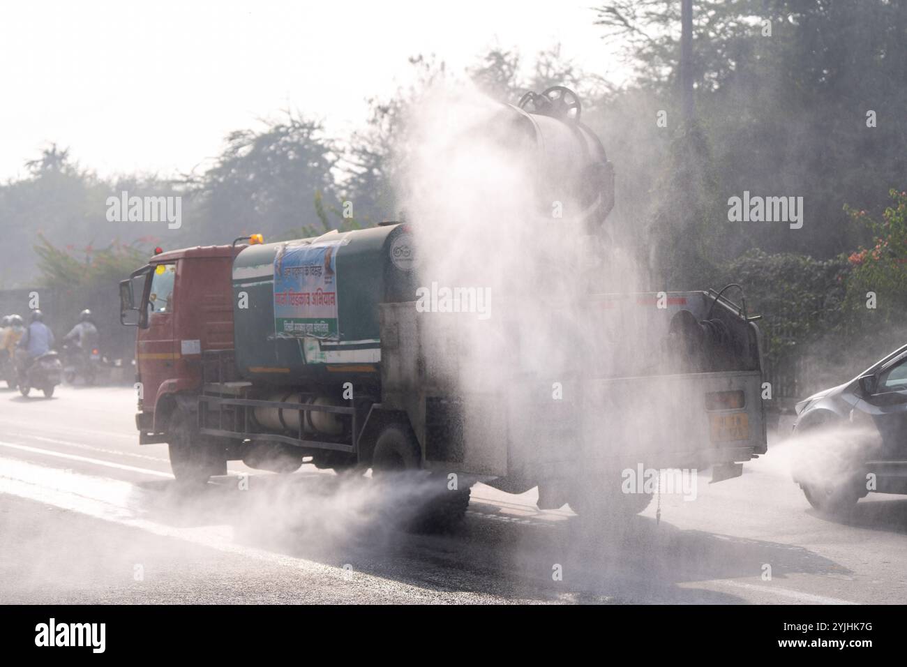 A vehicle spraying water to curb dust and pollution amid smoggy ...