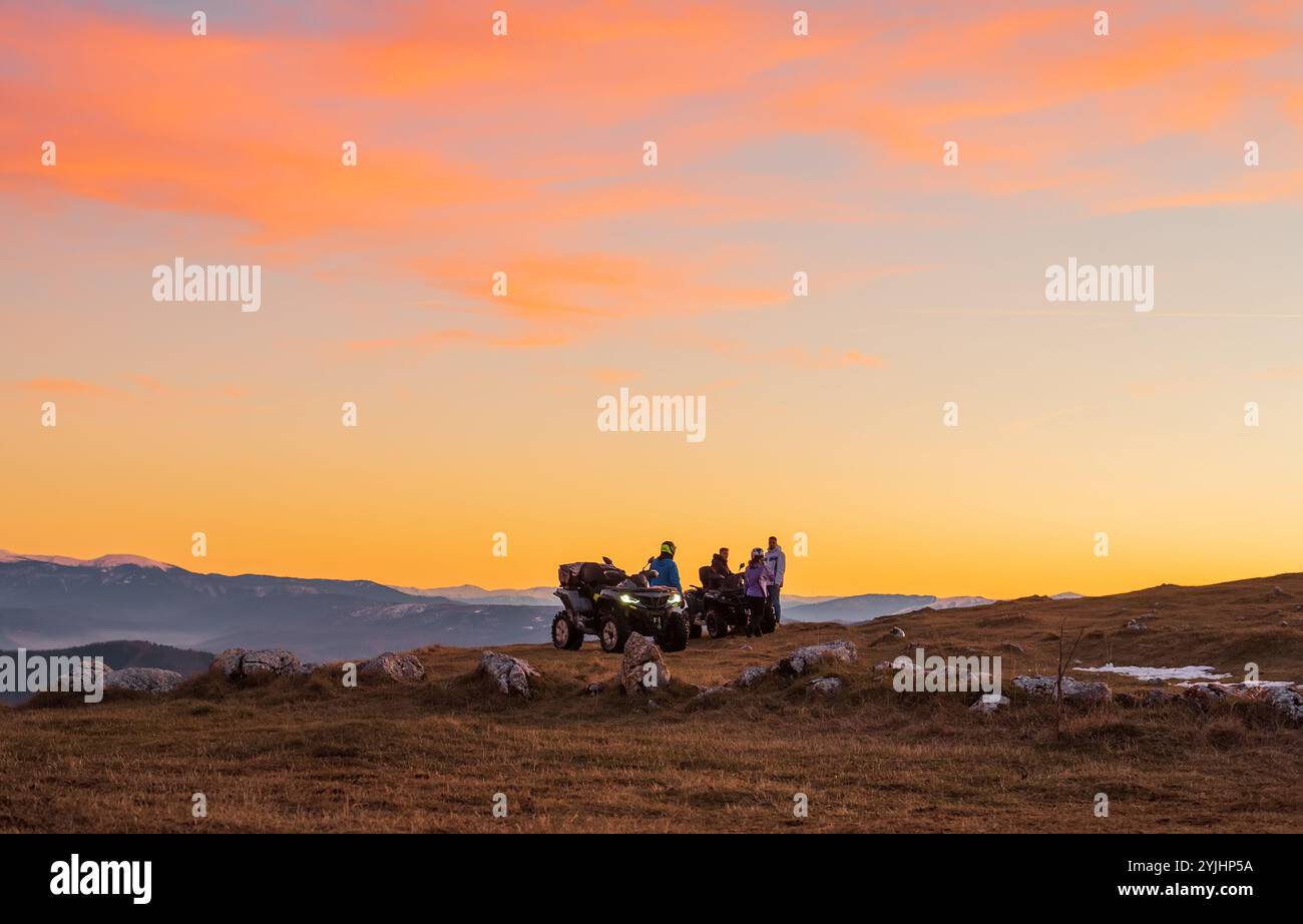 Group of friends riding quad bike atv off road on the mountain at ...