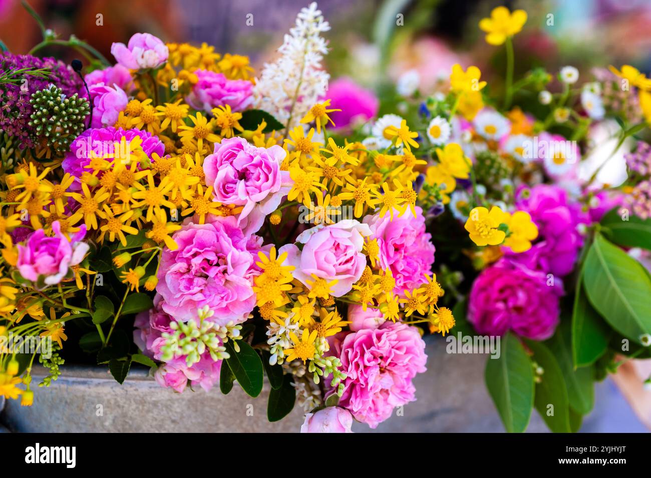 A bouquet of fresh mixed flowers in a container Stock Photo - Alamy