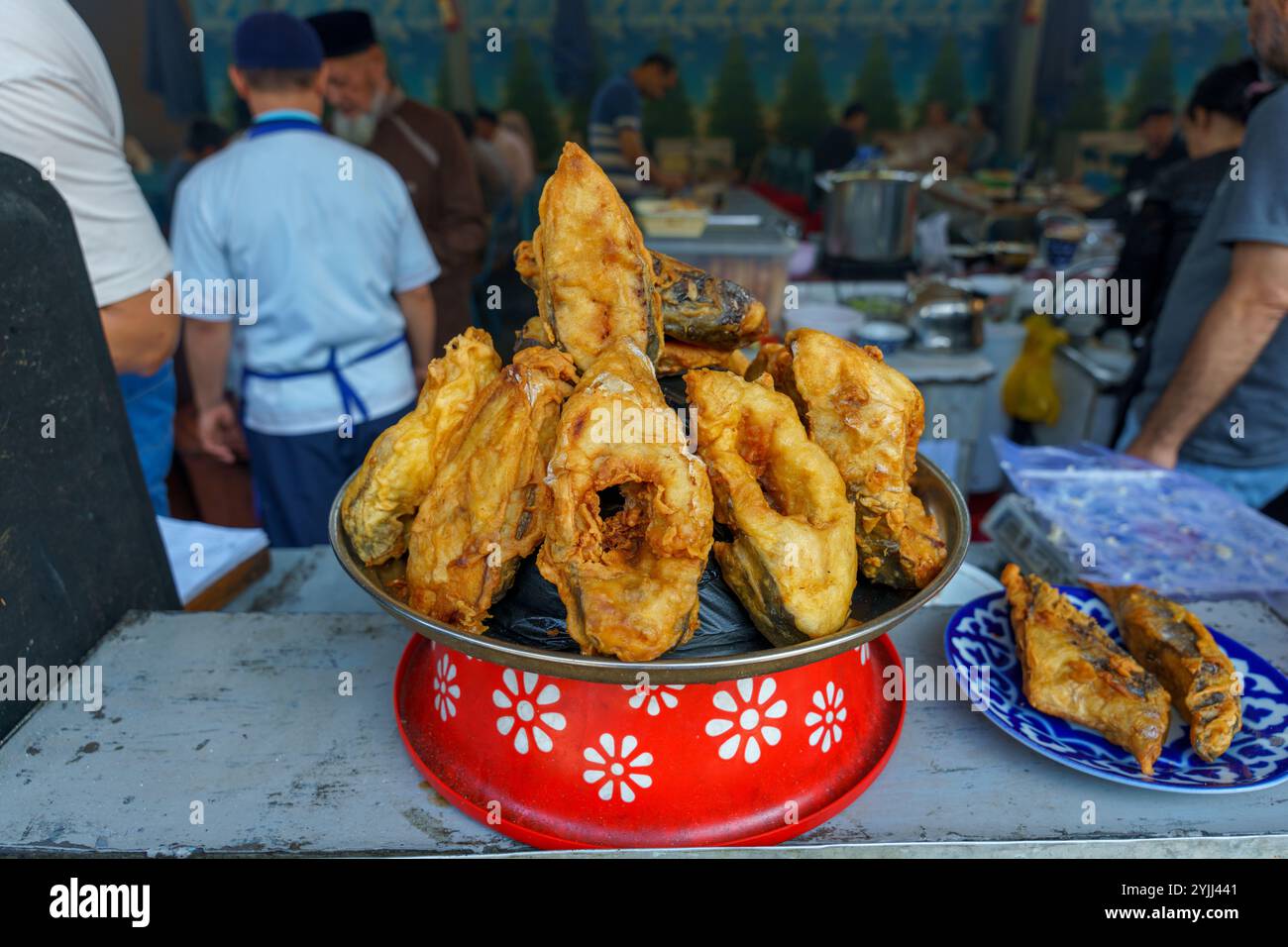 A red bowl with fish on it is on a table Stock Photo - Alamy