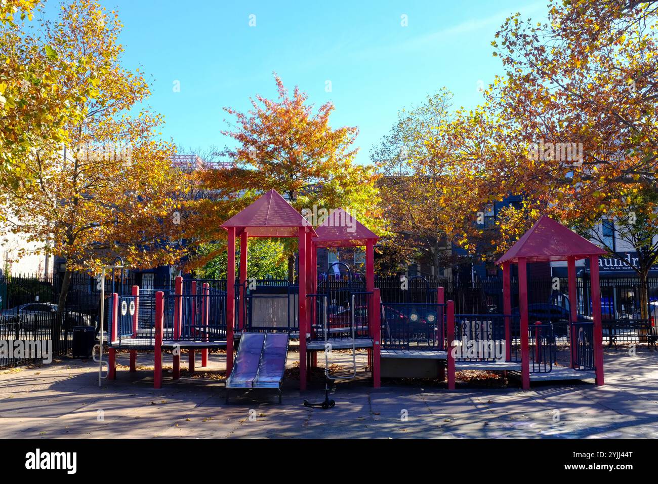 Red Kids Playground In Fall with Small Slide Stock Photo - Alamy