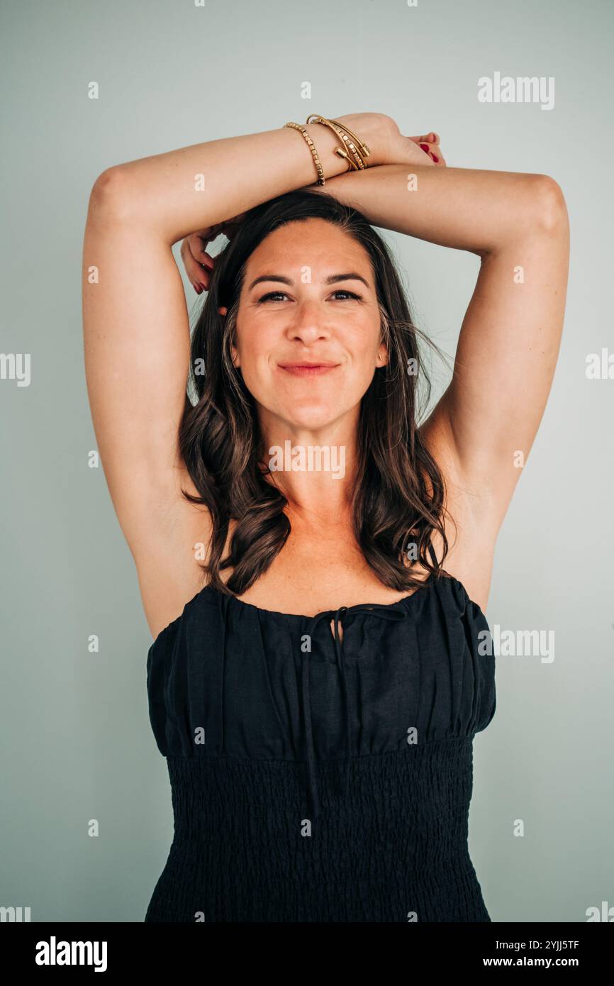 Smiling woman raised arms hi-res stock photography and images - Alamy