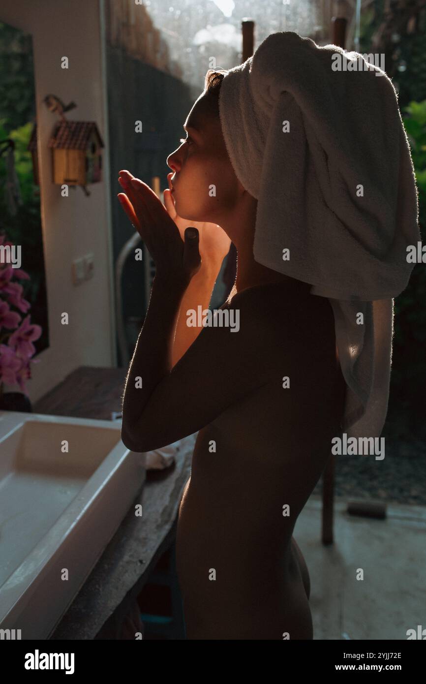 Young healthy natural woman applying hi-res stock photography and ...