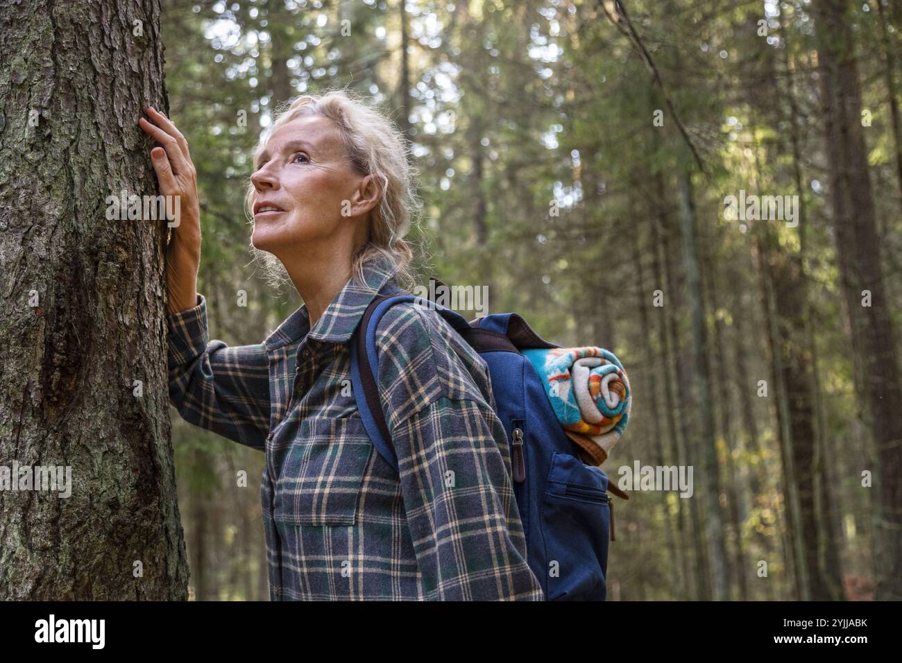 Senior active woman hiking alone with backpack Stock Photo - Alamy