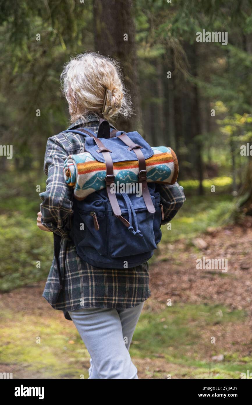 Senior active woman hiking alone with backpack Stock Photo - Alamy
