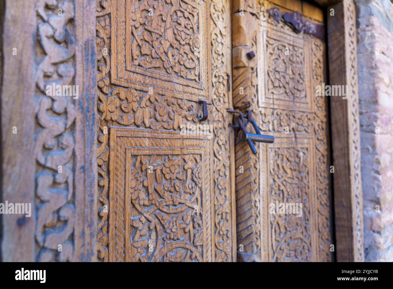 The door is carved with intricate designs and has a metal lock Stock ...