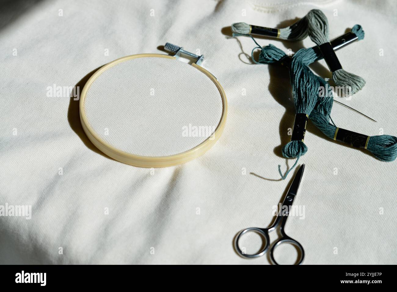 Embroidery supplies with thread, hoop, scissors on white fabric Stock ...