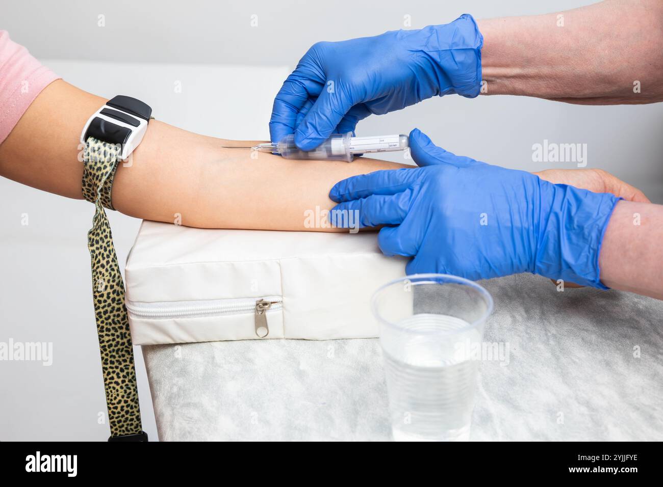 Close-up shot of healthcare worker wearing gloves takes a blood sample ...
